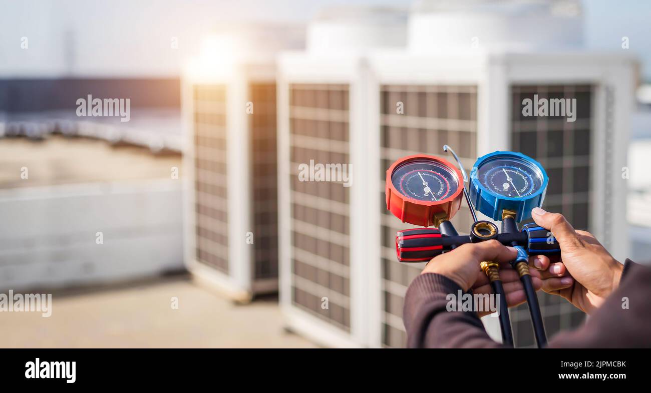 Air conditioner technician checking air conditioner operation Stock ...