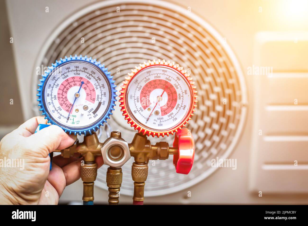 Air conditioner technician checking air conditioner operation Stock ...