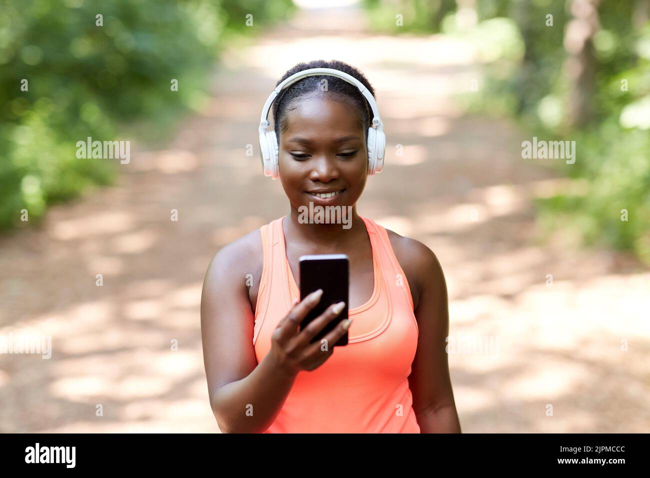 african american woman with headphones and phone Stock Photo - Alamy