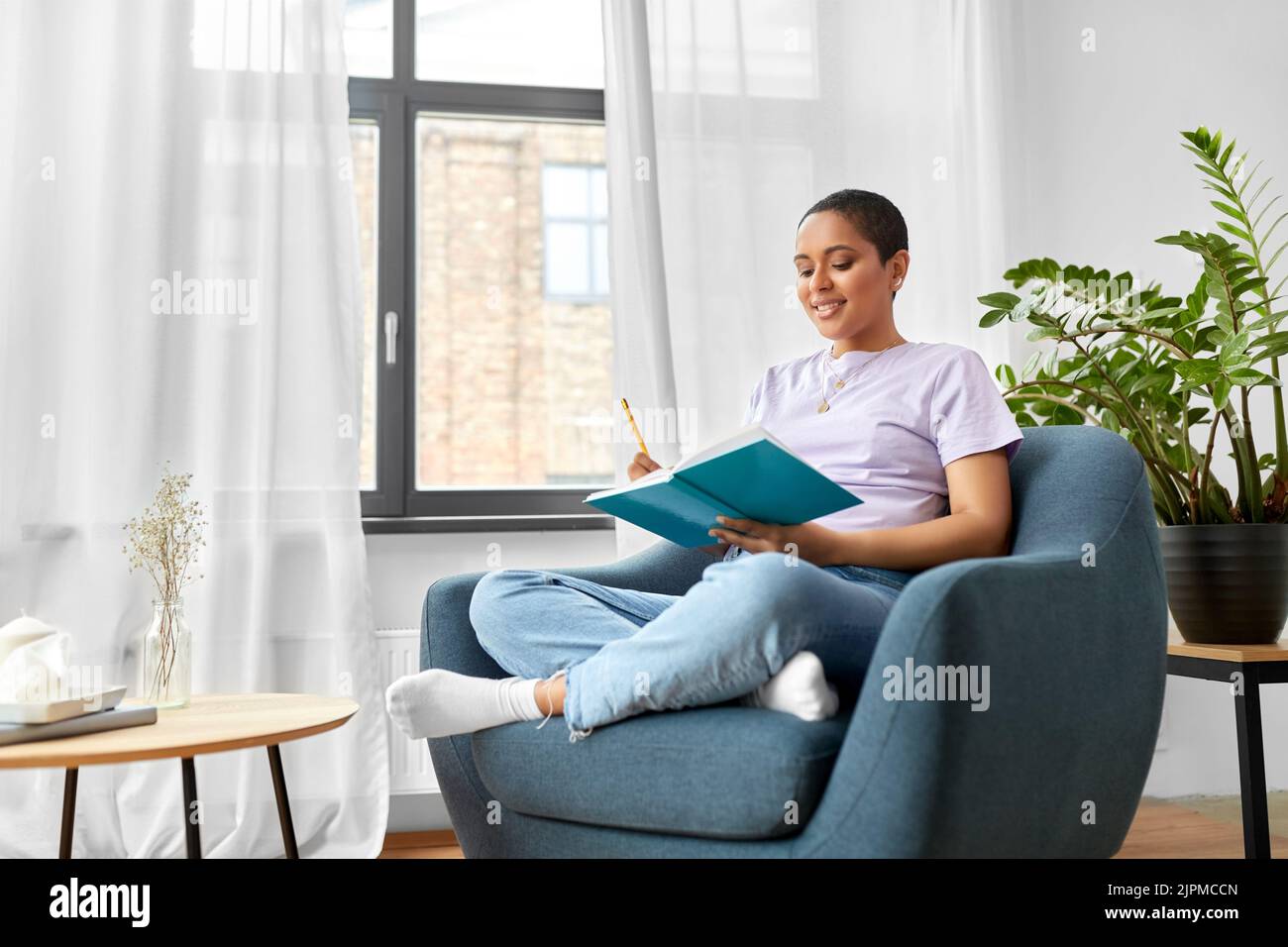 happy african american woman with diary at home Stock Photo - Alamy