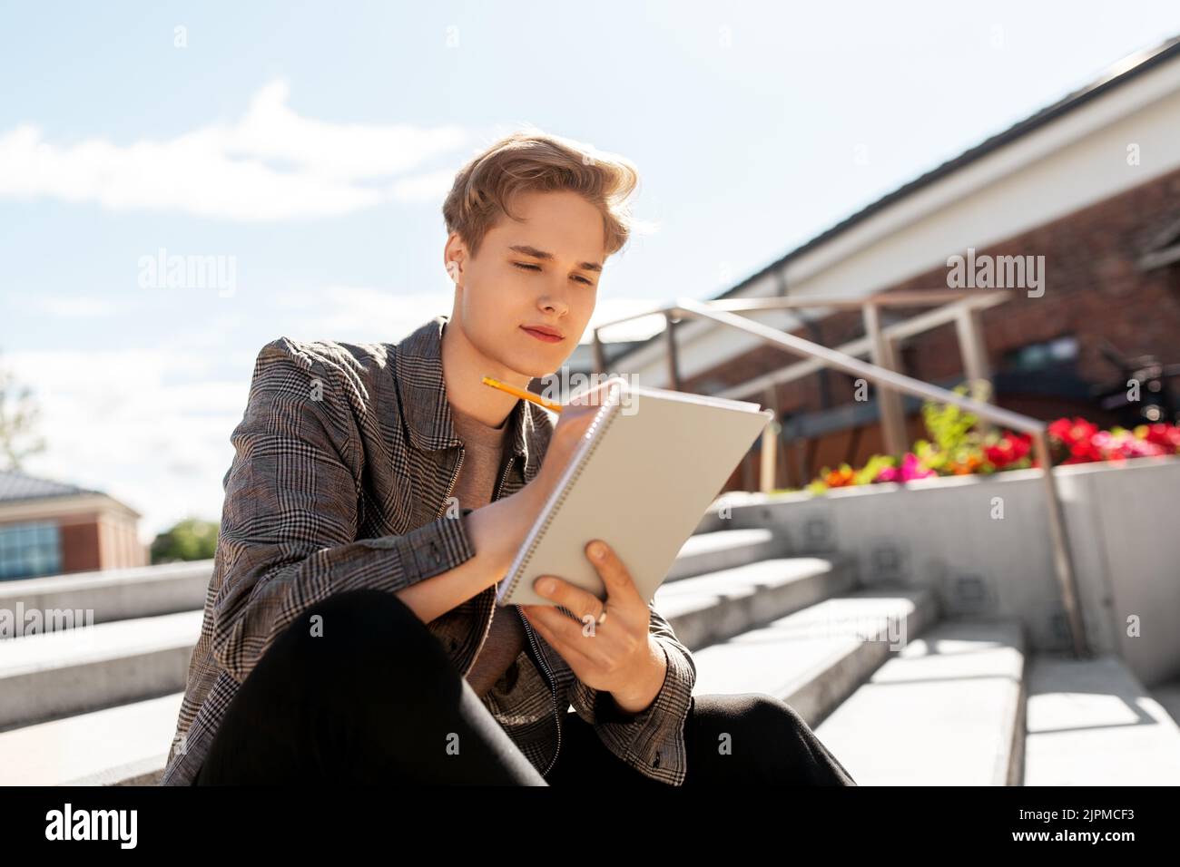 young man with notebook or sketchbook in city Stock Photo - Alamy