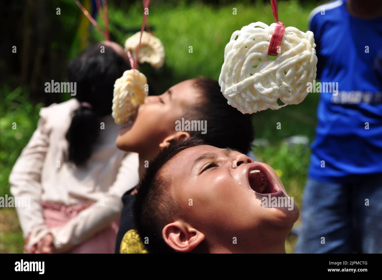 West Java, Indonesia - August 17, 2022: Little child are following the ...