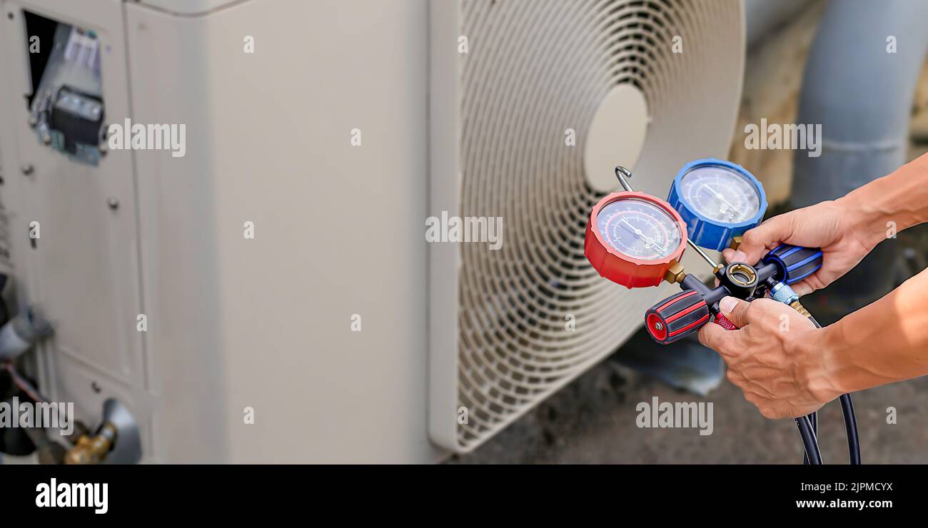 Air conditioner technician checking air conditioner operation Stock ...