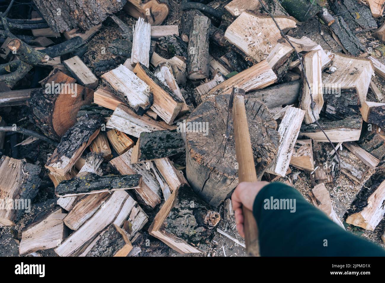 The ax lies on the wood. Firewood chopping. Preparation of firewood for ...