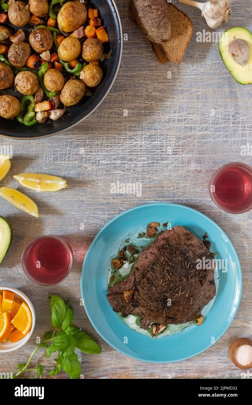Large fried piece of ham meat in a pan with vegetables and spices ...