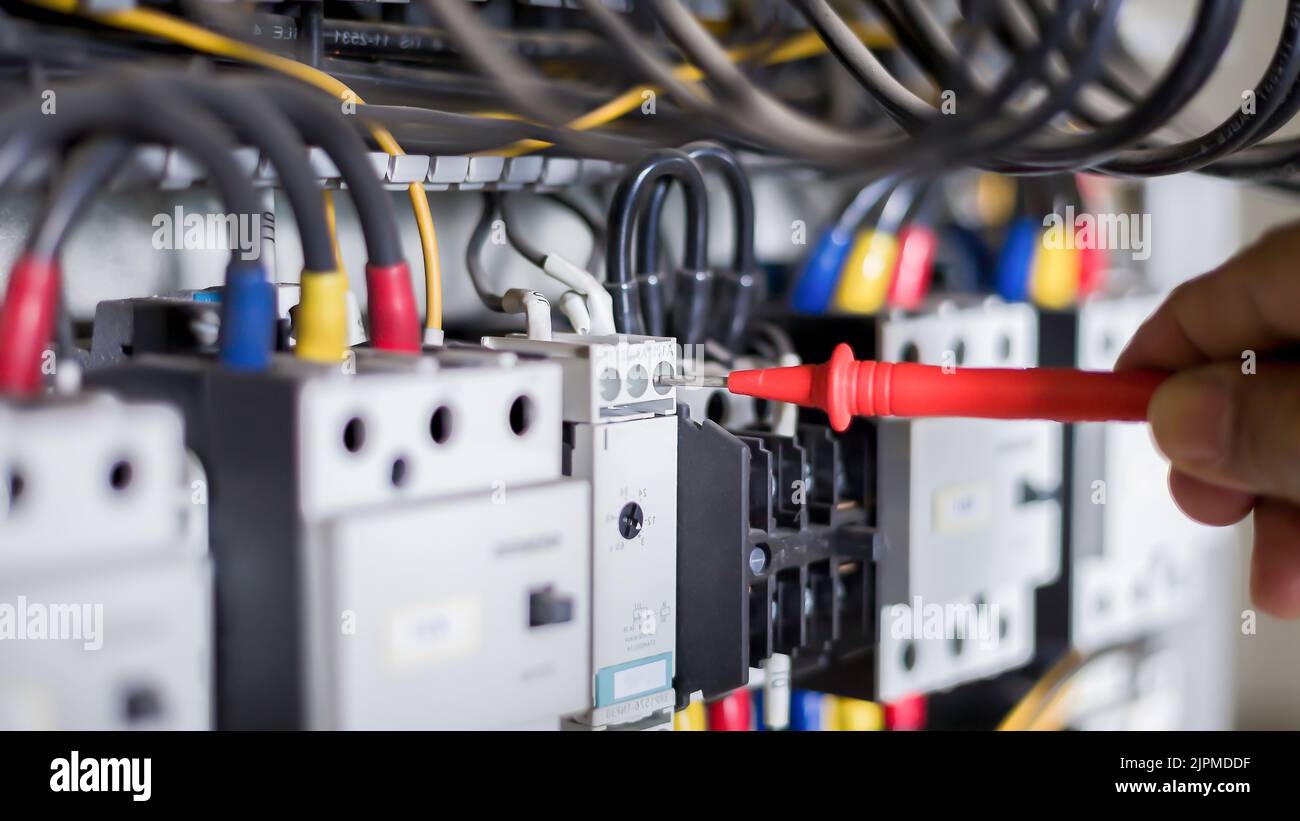 Electrical engineer checking the operation of electrical control ...