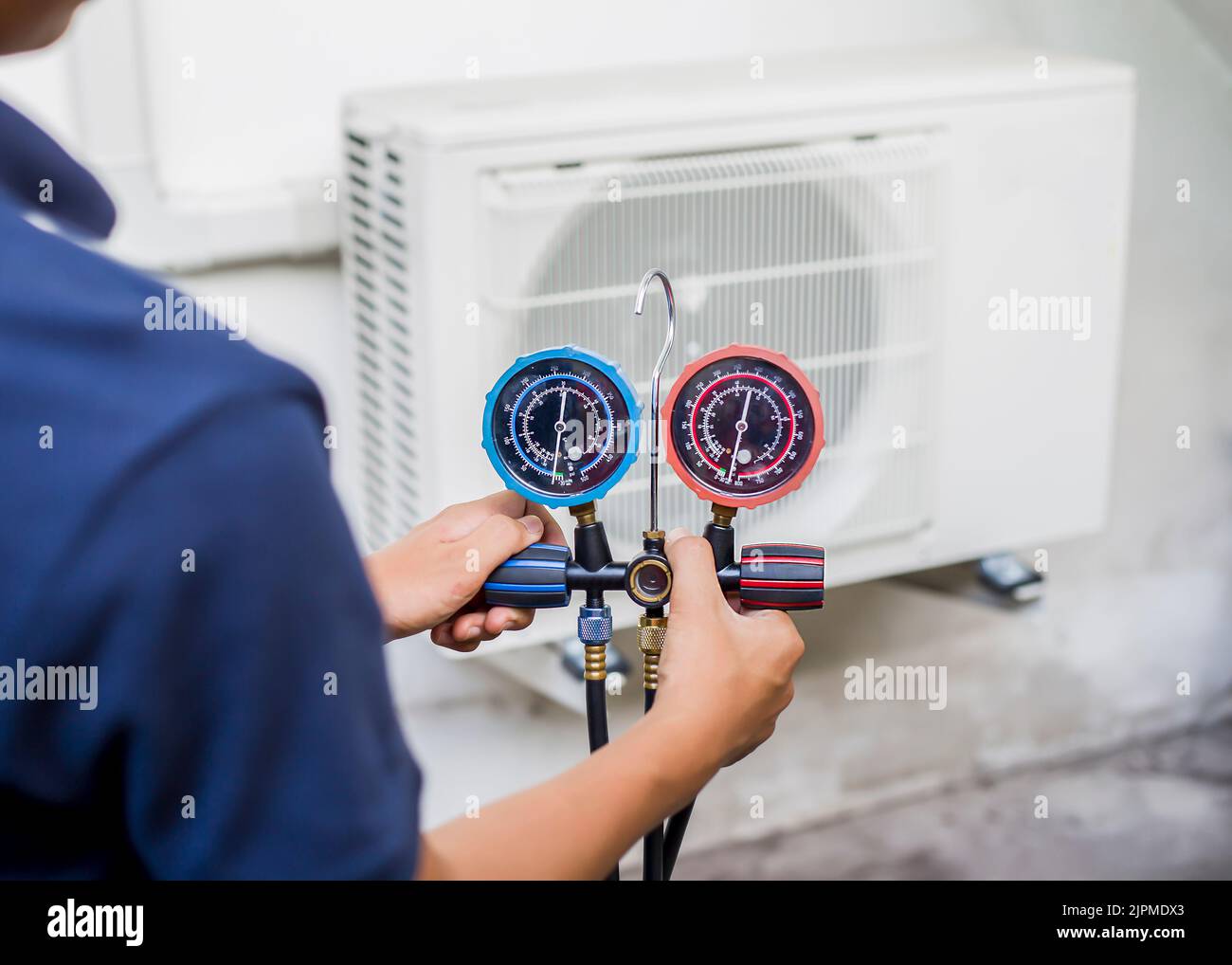 Air conditioner technician checking air conditioner operation Stock ...
