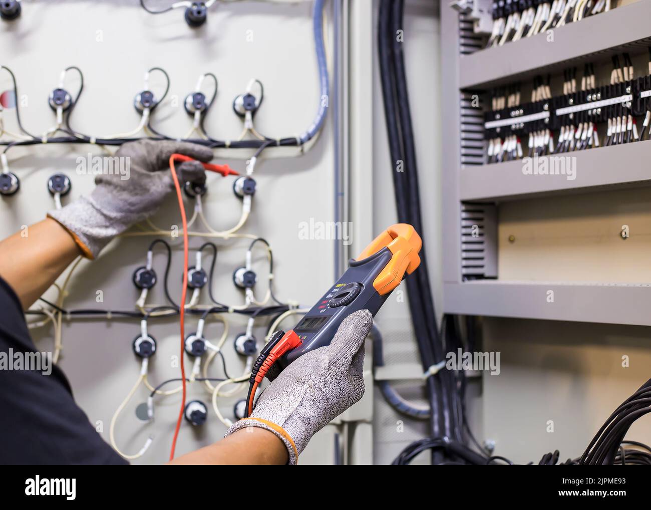 Electrical engineer checking the operation of electrical control ...