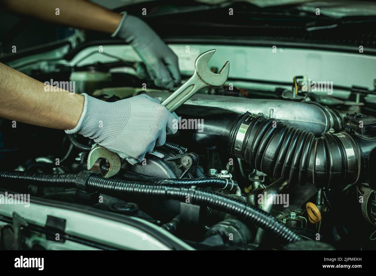 Mechanic works on the engine of the car e in the garage,car repair ...