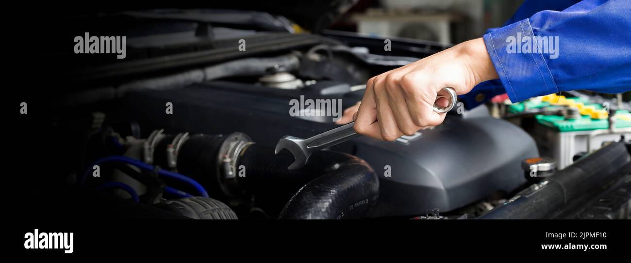 Mechanic works on the engine of the car e in the garage,car repair ...