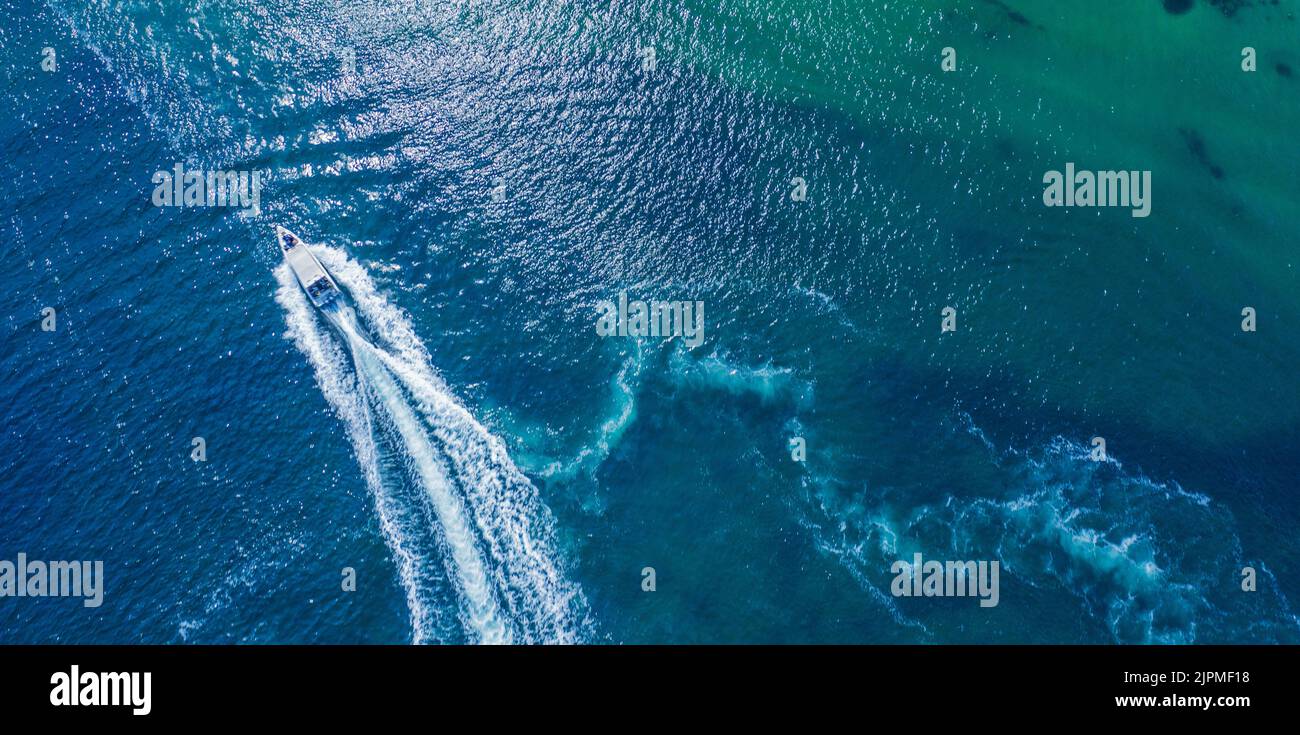 Rest on the water. A speed boat moves in a circle on the surface of the ...