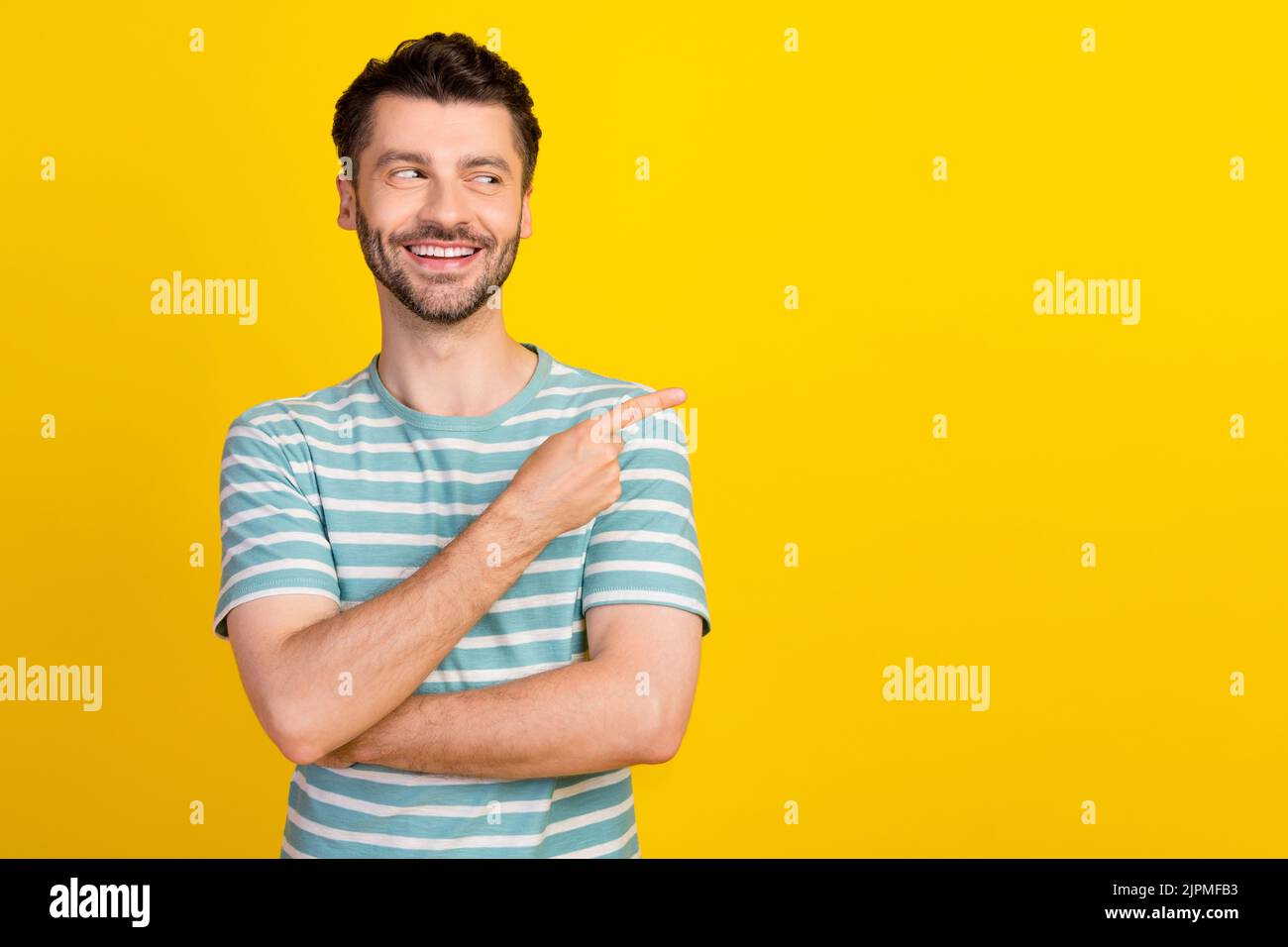 Closeup photo of young attractive guy finger directing look empty space ...