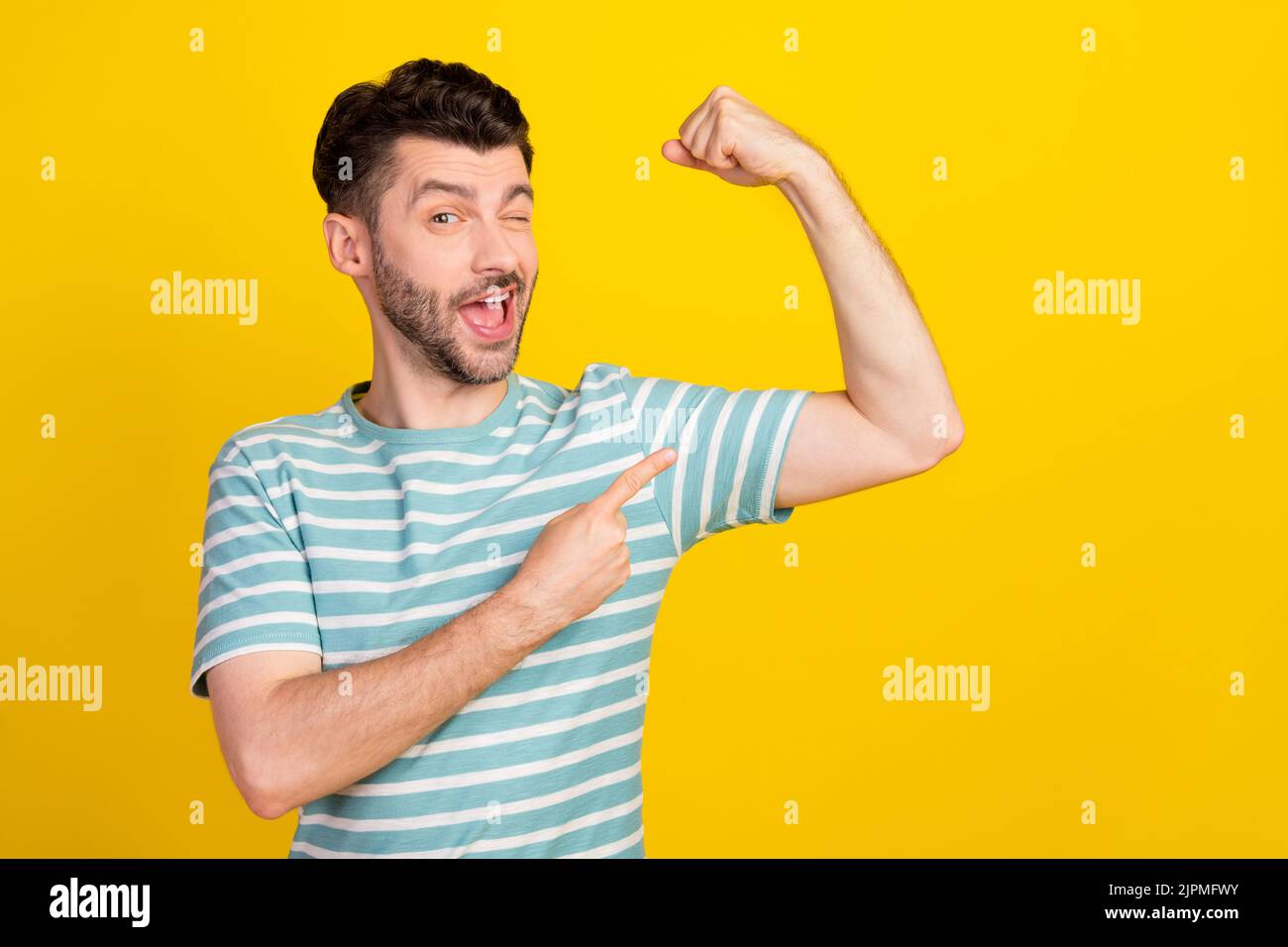 Closeup photo of young funny guy sporty showing his cool big biceps ...
