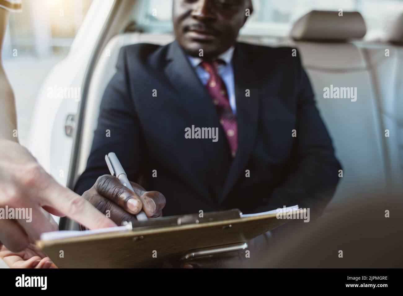 Business concept of a handsome dark-skinned man in a suit and glasses ...