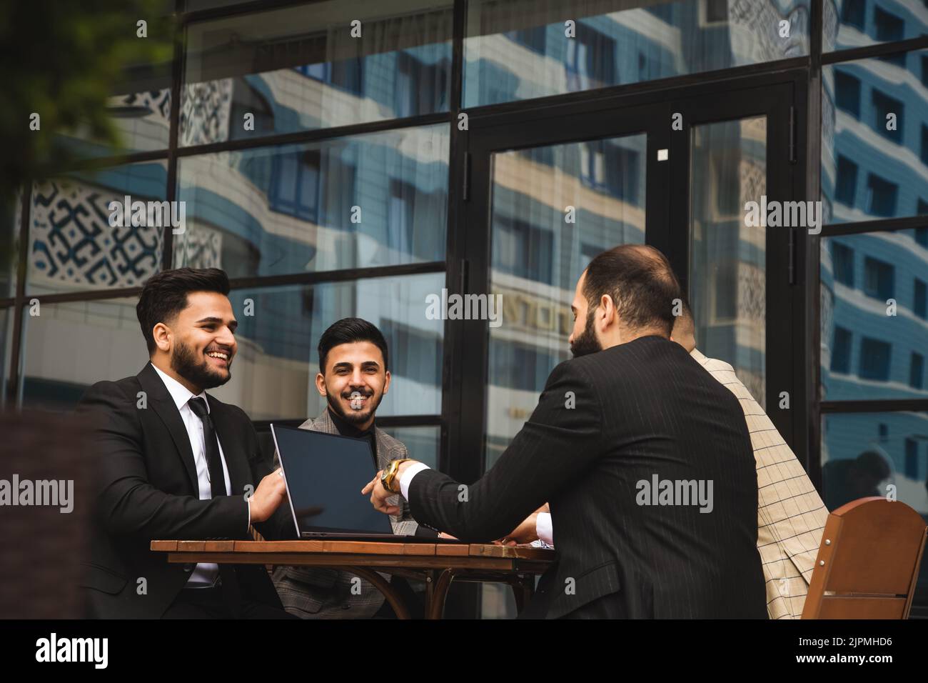 Business people outdoors. Employee meeting. Conversation and interaction of partners. Workers ...