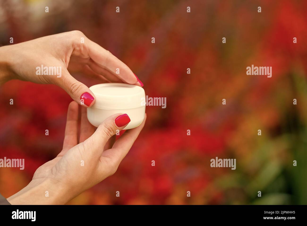 female hand open shampoo bottle on colorful background with copy space ...