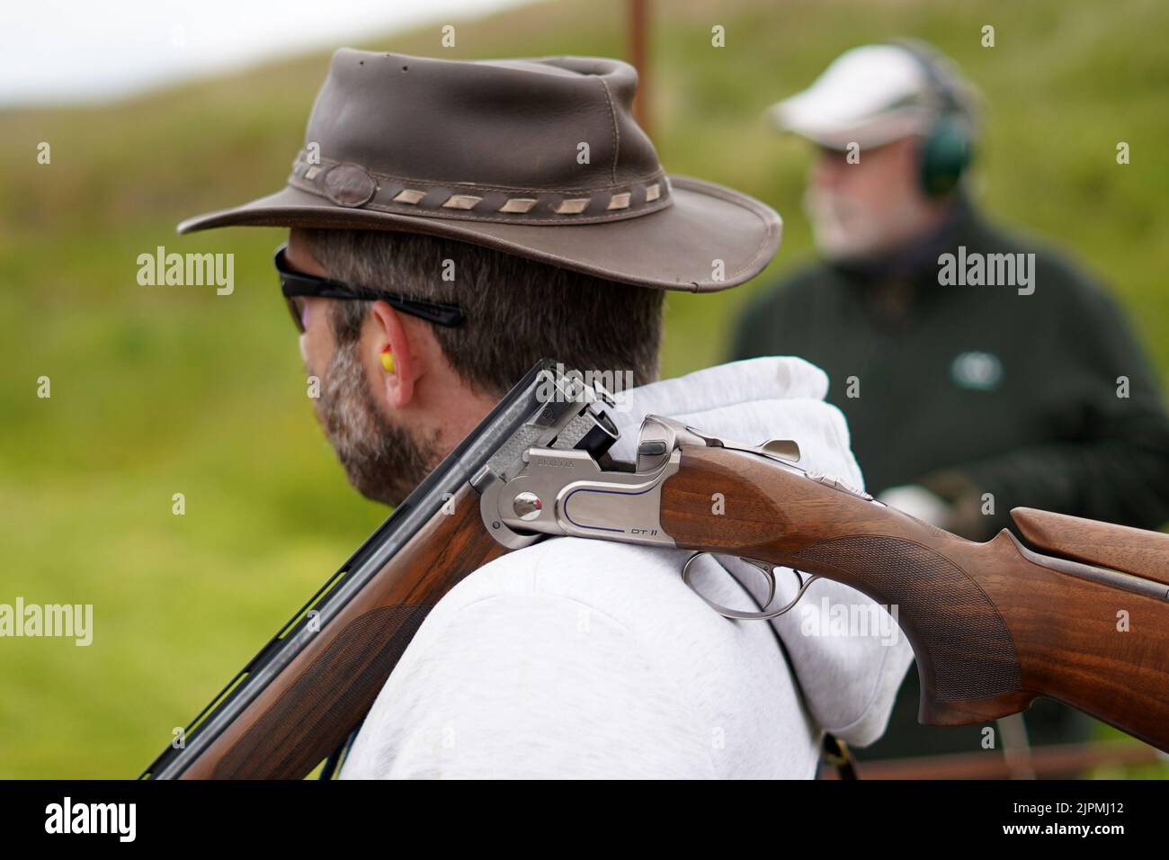 White man in a hat with a shotgun over his shoulder Stock Photo - Alamy