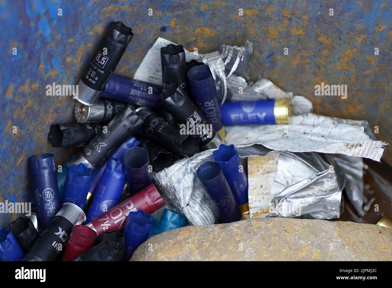 Used shotgun cartridges in the bottom of a barrel Stock Photo - Alamy