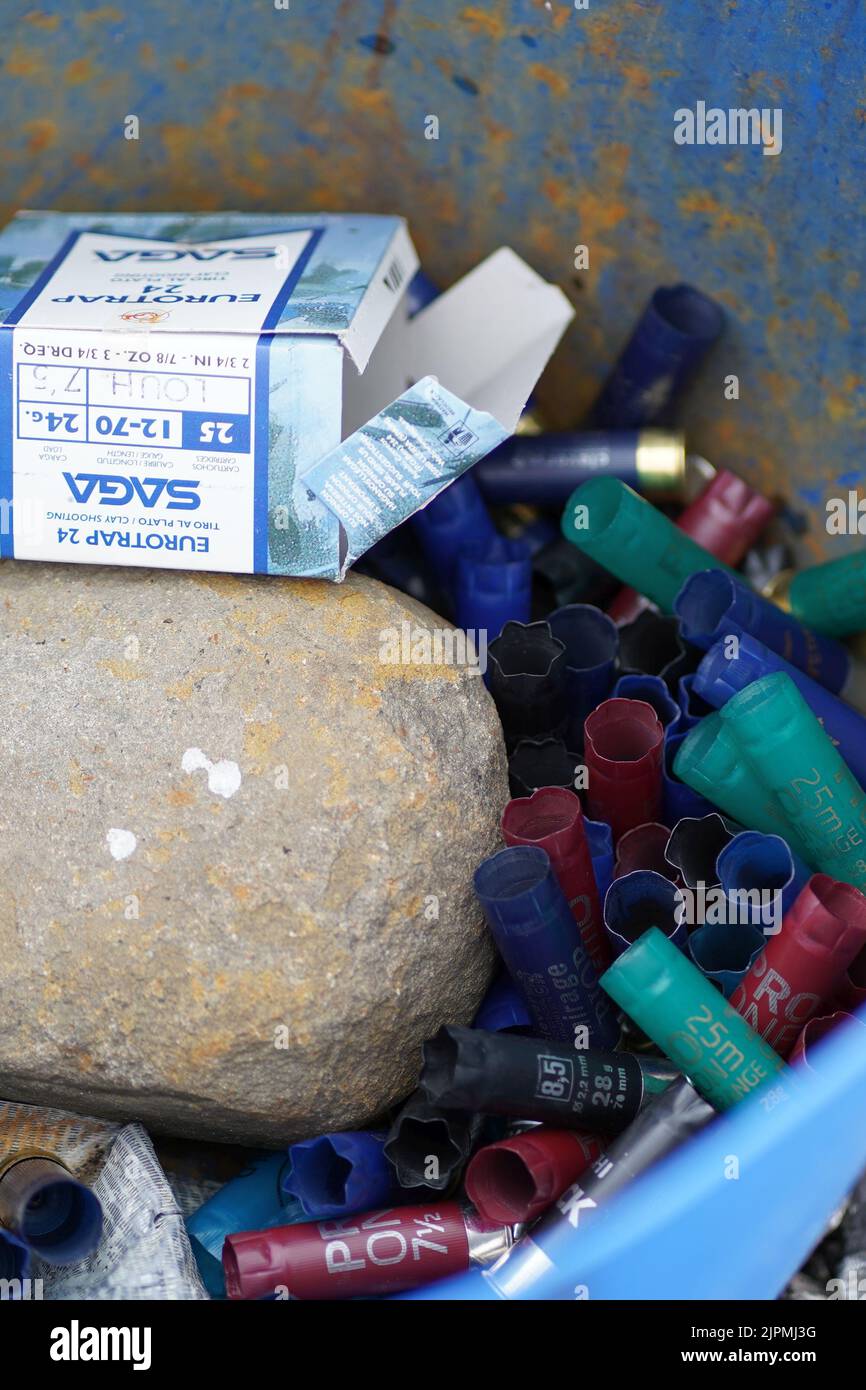 Used shotgun cartridges in the bottom of a barrel Stock Photo - Alamy