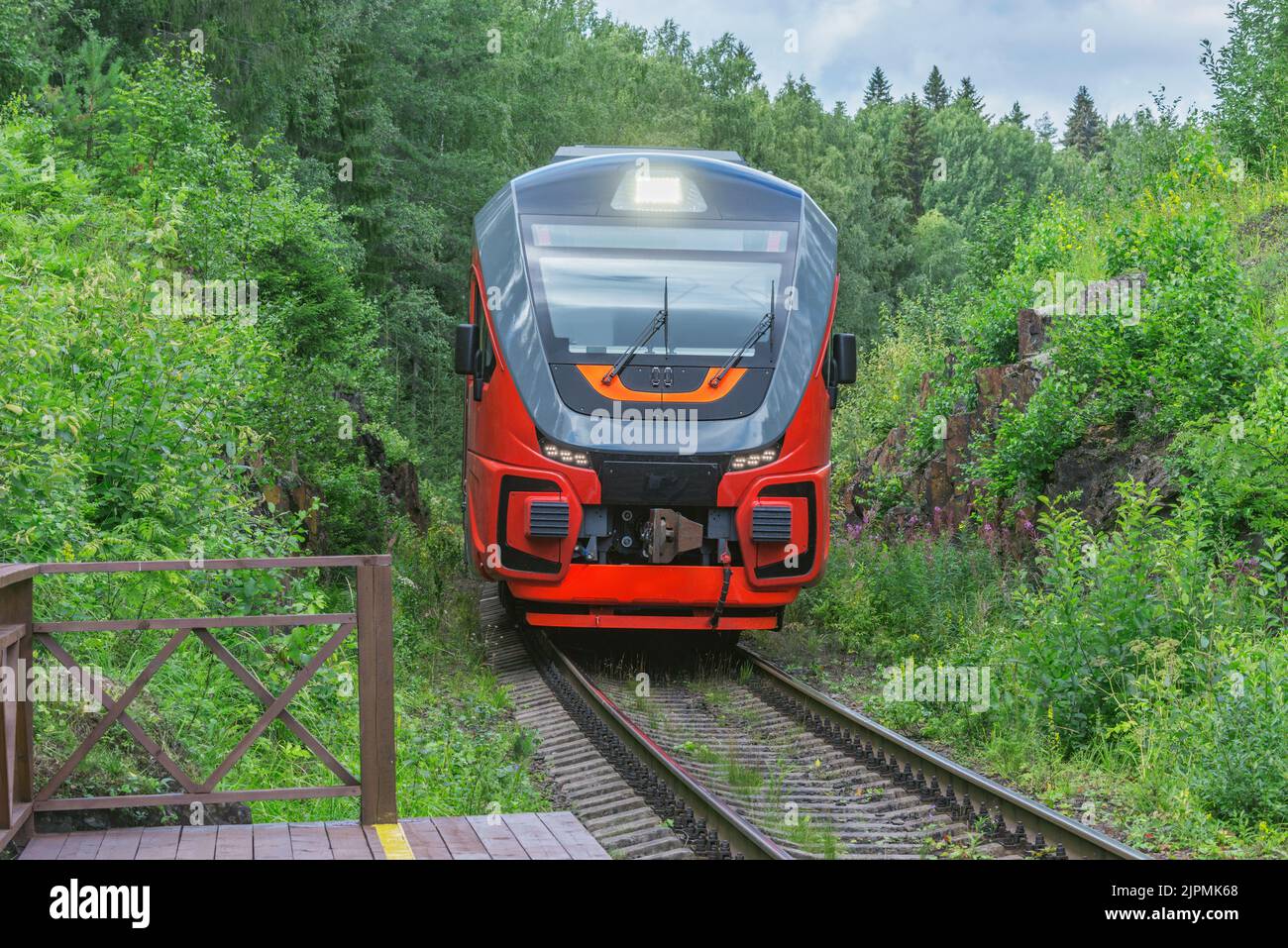 Passenger train approaches to the wooden platform Stock Photo - Alamy