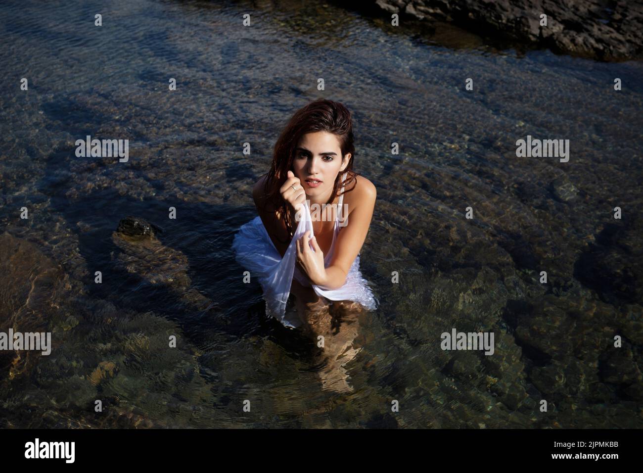 From above of confident young female model with long brown hair in ...