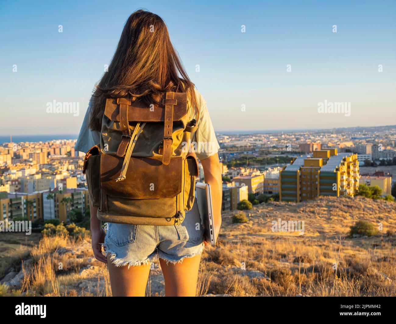 Woman, adventurous girl with outdoor backpack and laptop. Digital nomad ...