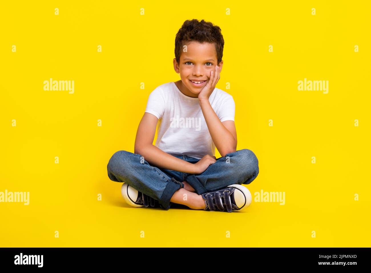 Full length photo of little boy sit wear t-shirt jeans sneakers ...