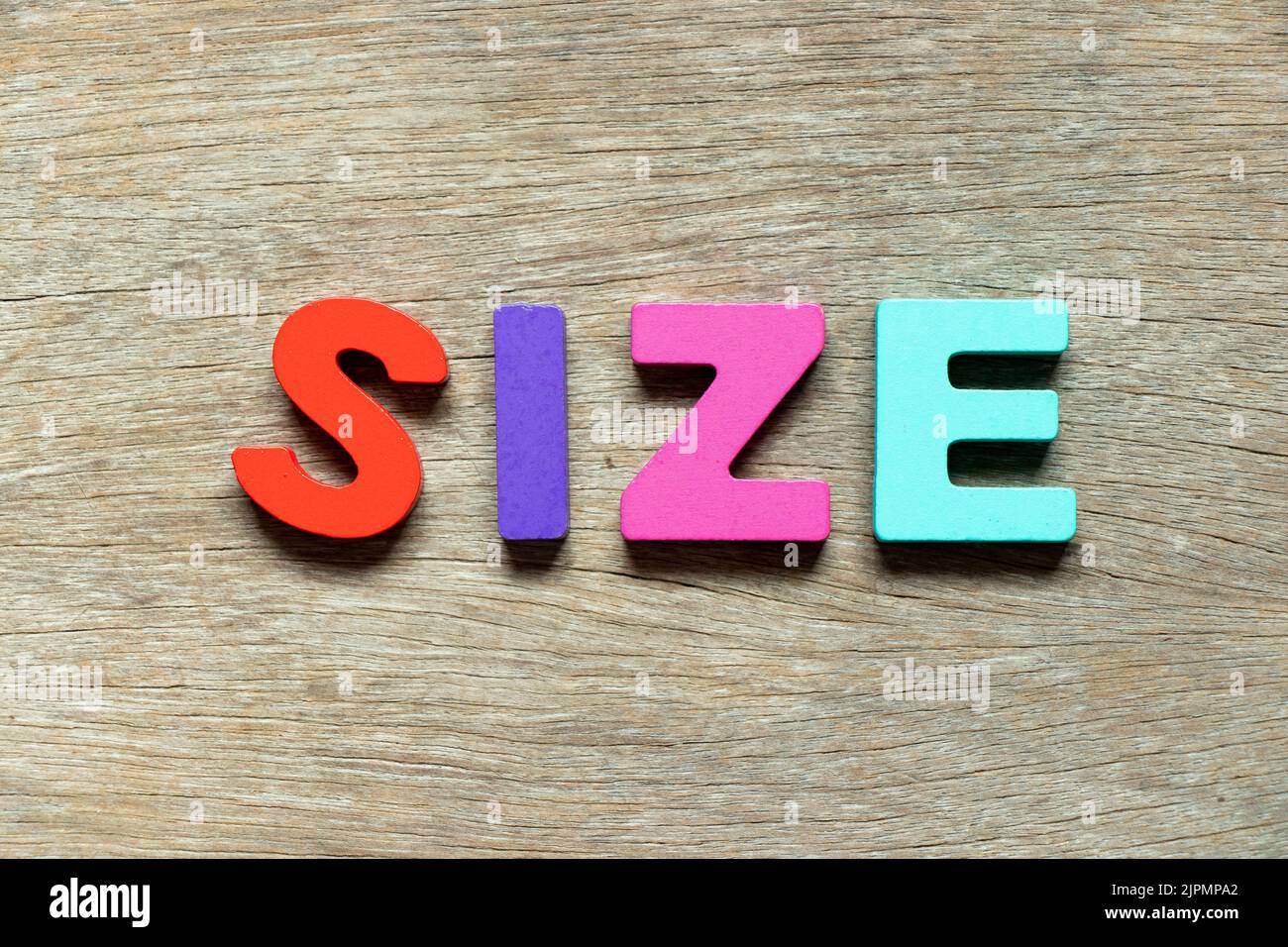 Color alphabet letter in word size on wood background Stock Photo - Alamy
