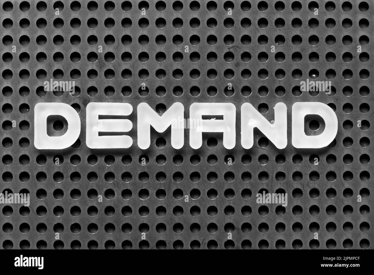 White alphabet letter in word demand on black pegboard background Stock Photo - Alamy