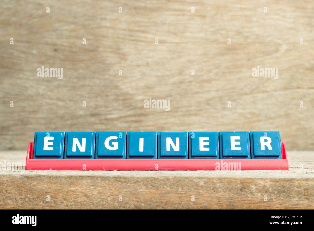 Tile letter on red rack in word engineer on wood background Stock Photo ...