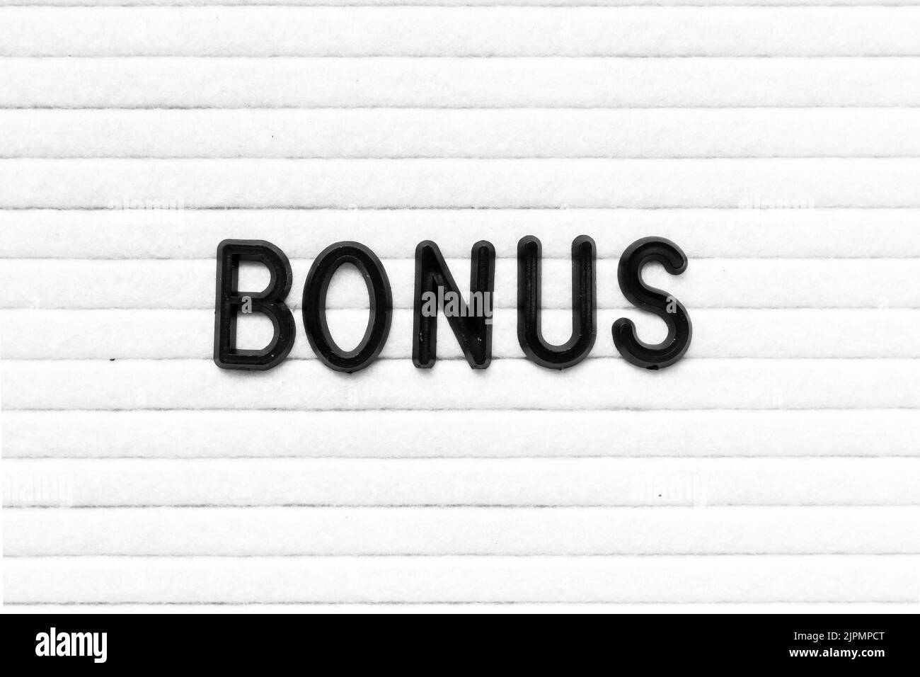 Black color letter in word bonus on white felt board background Stock ...