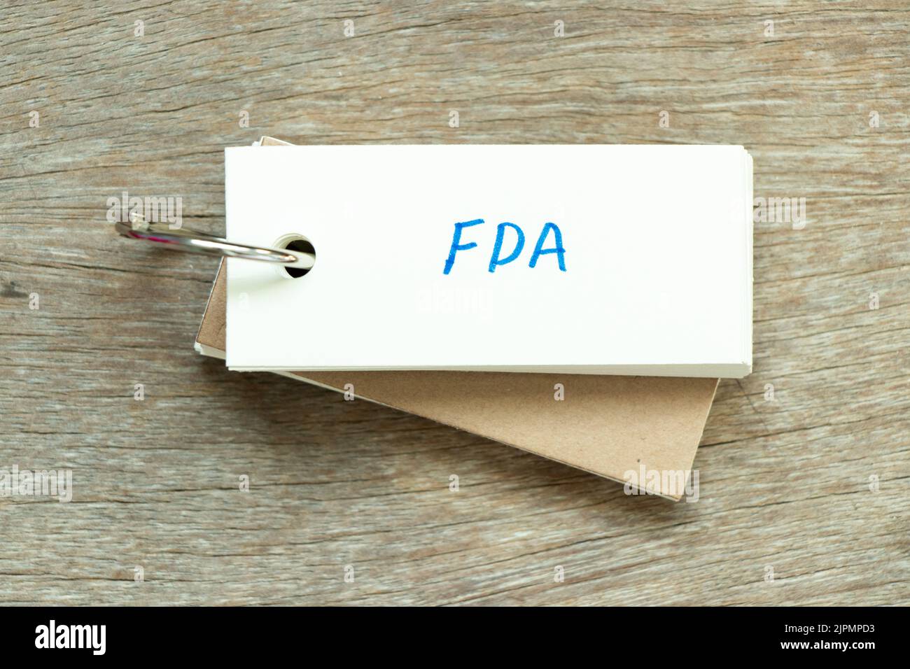 Flash card with handwriting word FDA (abbreviation of food and drug ...