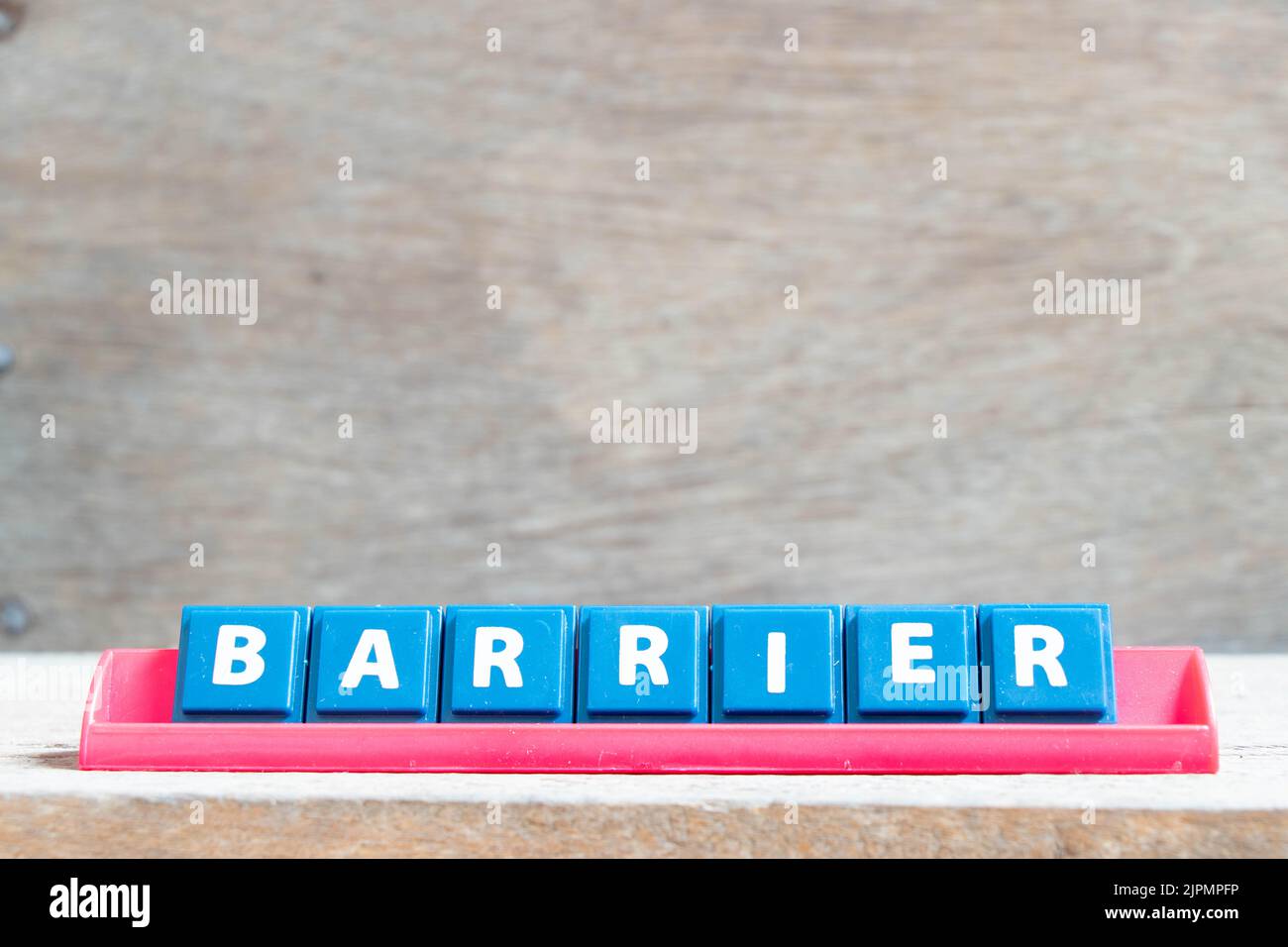 Tile alphabet letter with word barrier in red color rack on wood ...