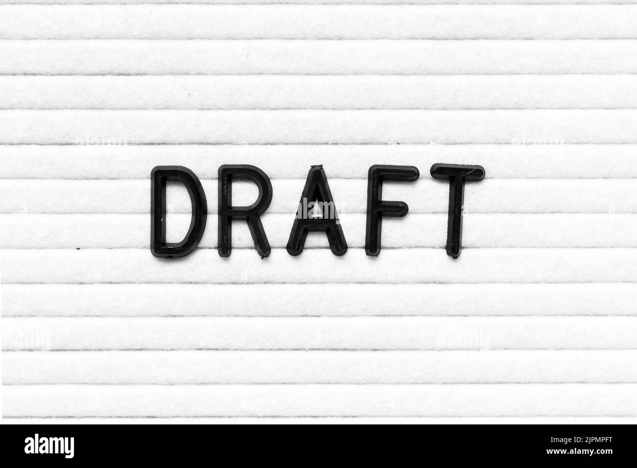 Black color letter in word draft on white felt board background Stock ...