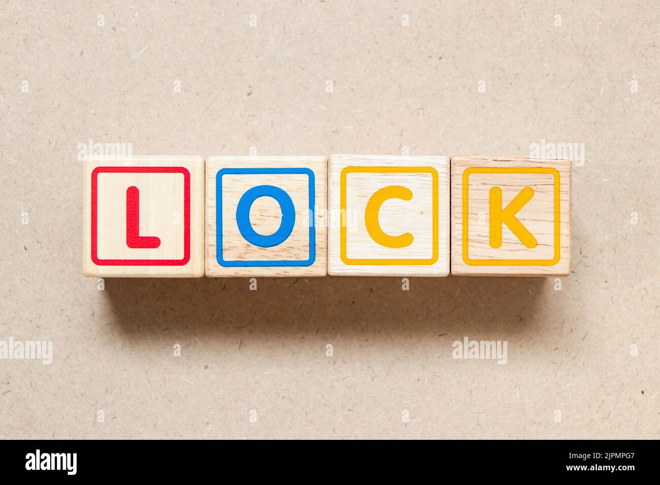 Color letter block in word lock on wood background Stock Photo - Alamy