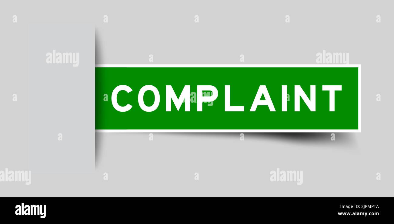 Inserted green color label sticker with word complaint on gray ...