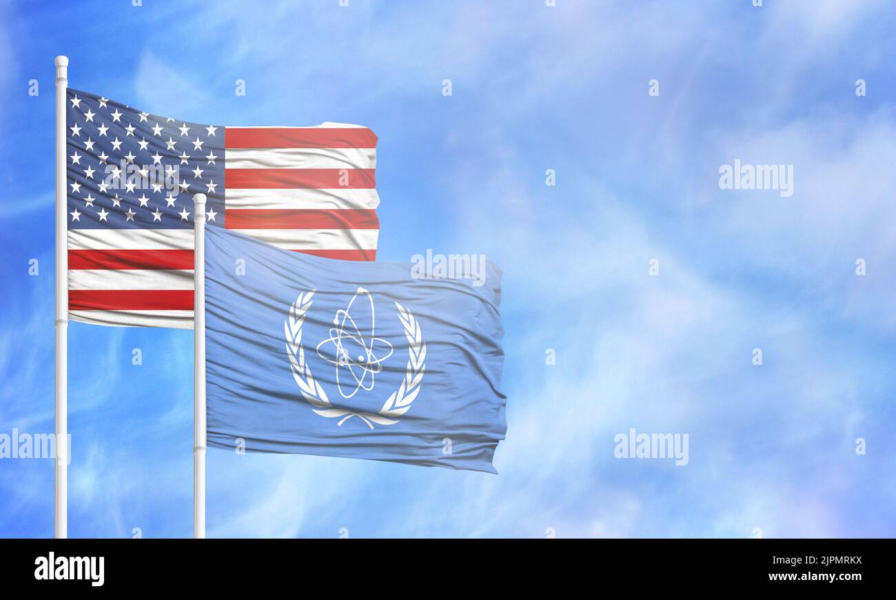 Waving American flag and flag of IAEA Stock Photo - Alamy
