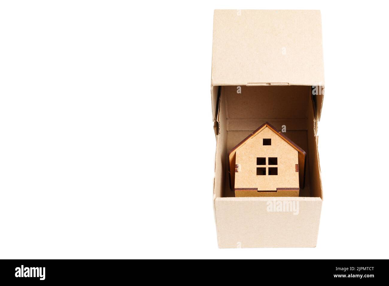 Wooden self-assembly toy house inside a cardboard box isolated on white ...
