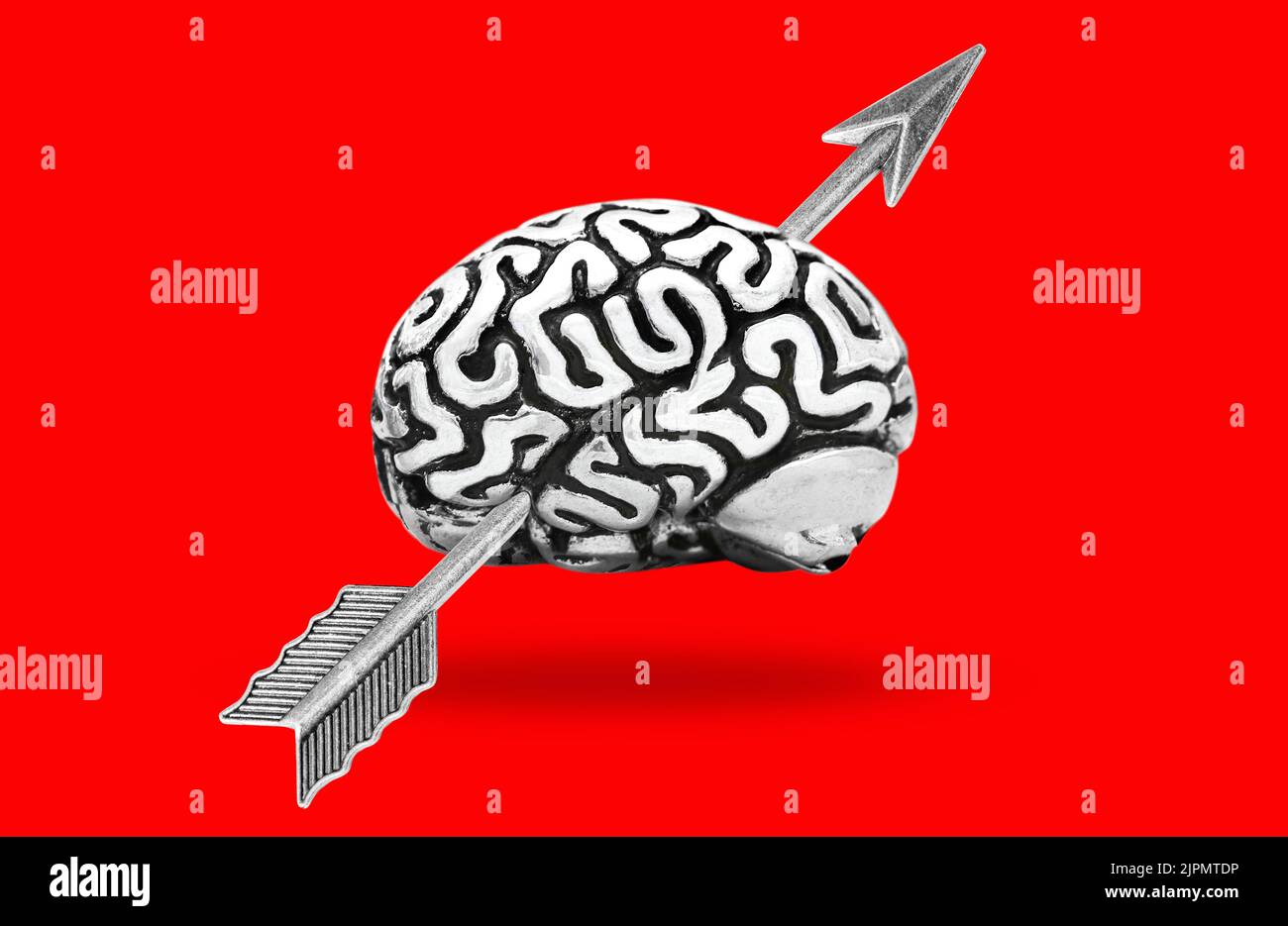 Feathered steel arrow entered a human brain isolated on red background ...