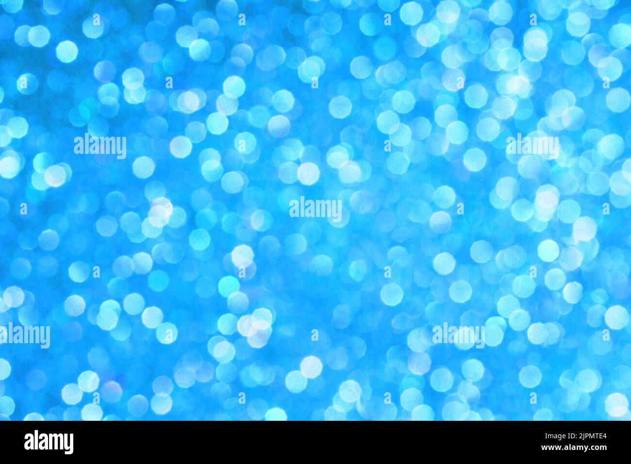 Abstract background made from defocused blue and white light circles ...