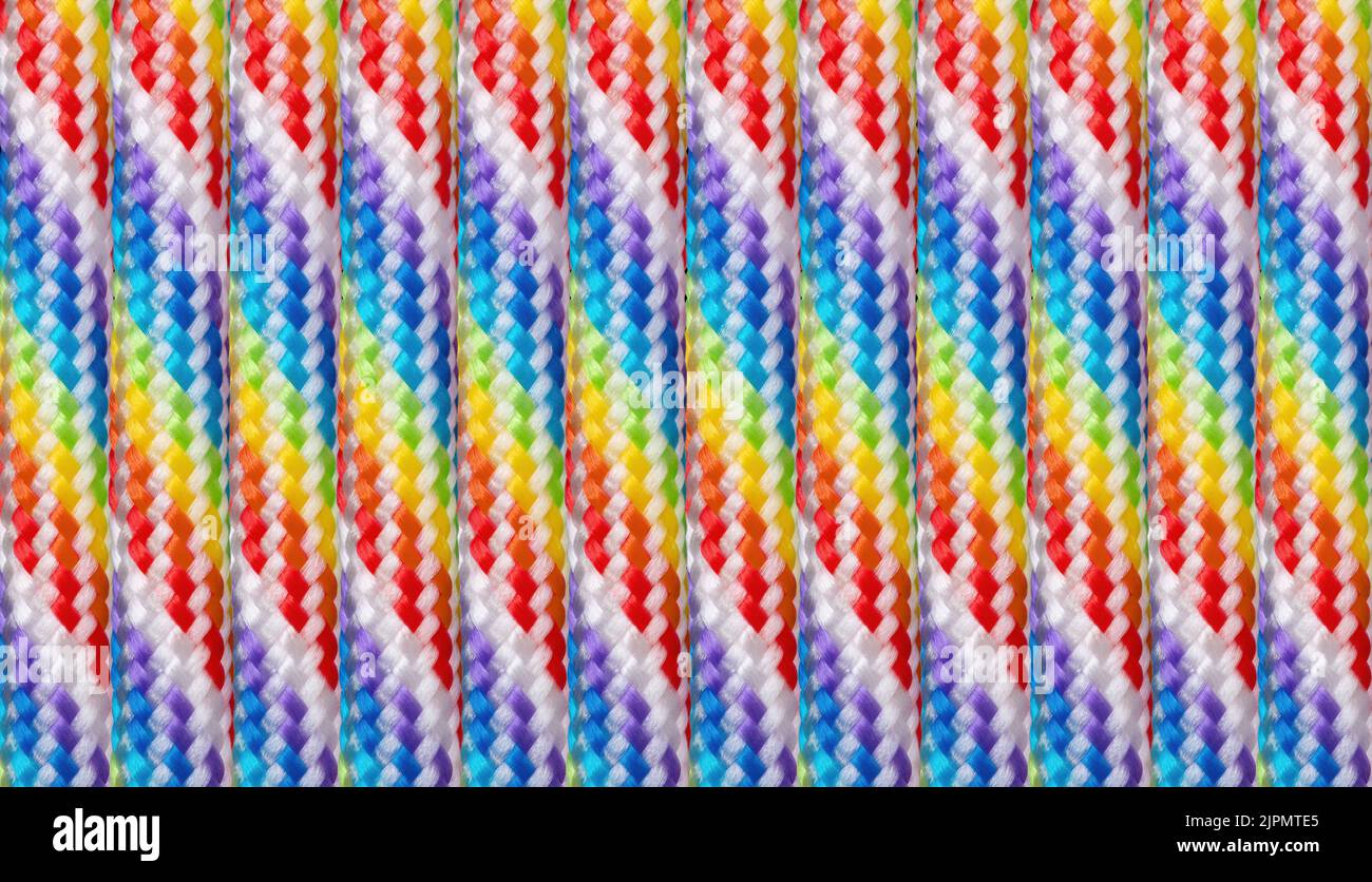 Abstract background made from a bunch of rainbow colored braided cotton ...