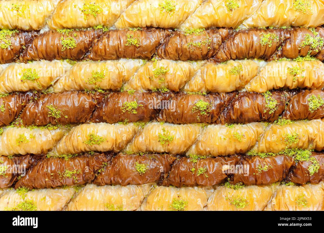 Slices of traditional pistachio and cocoa turkish baklava background ...
