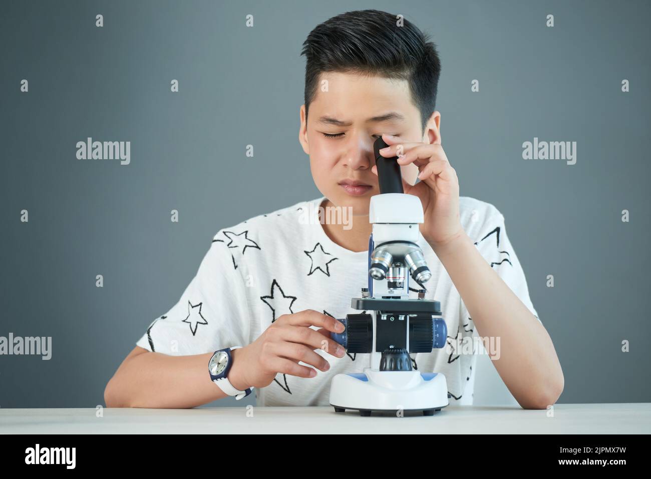 Waist-up portrait of handsome teenage boy with stylish haircut looking ...