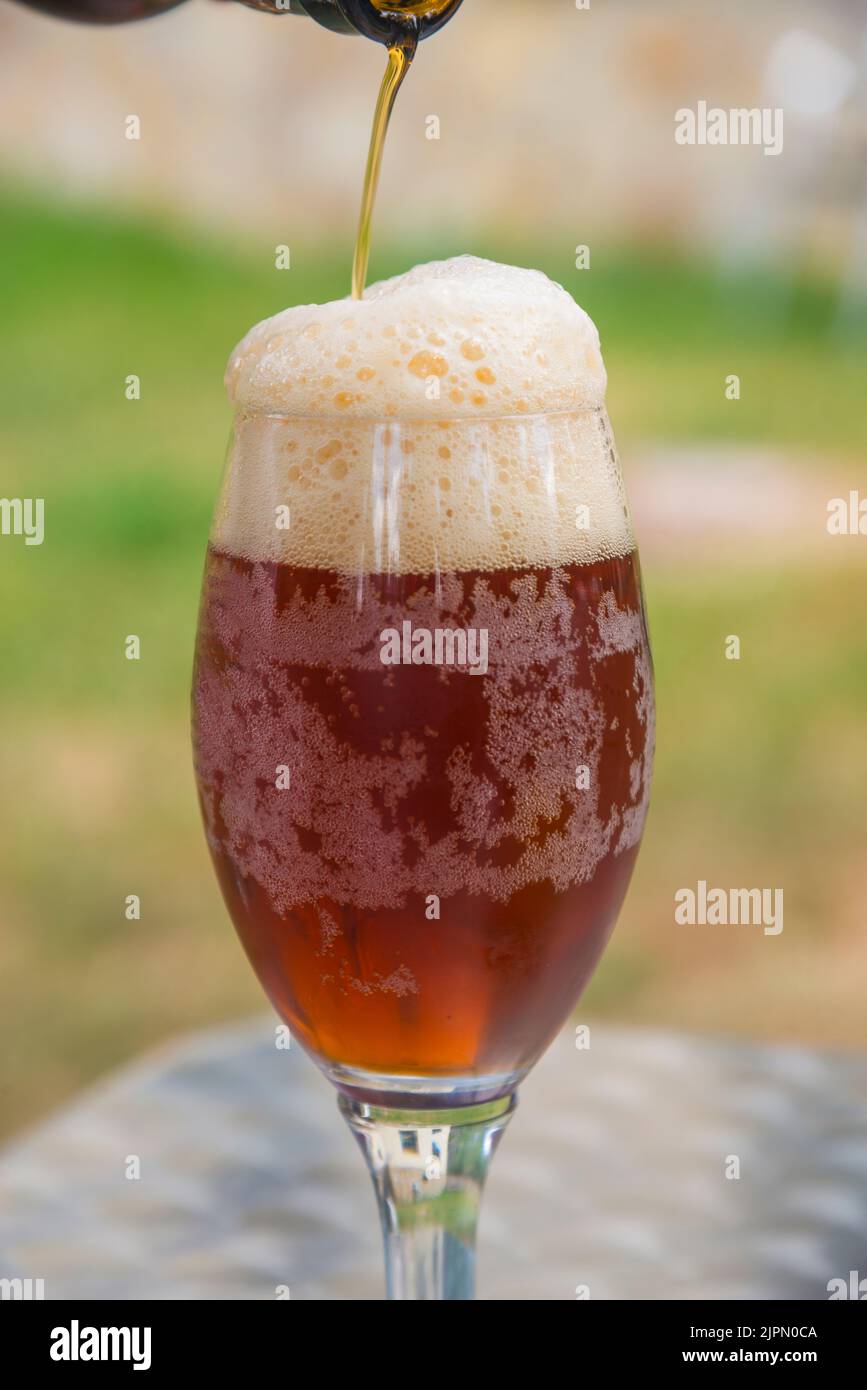 Pouring beer in a glass Stock Photo - Alamy