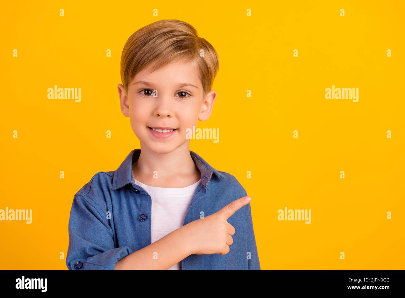 Photo of cheerful positive person indicate finger empty space offer ...