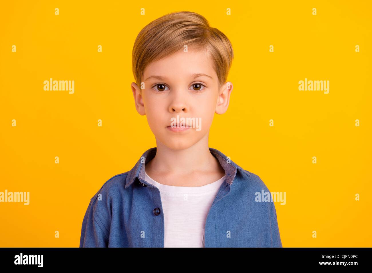 Photo of nice calm school boy look camera no emotions isolated on ...