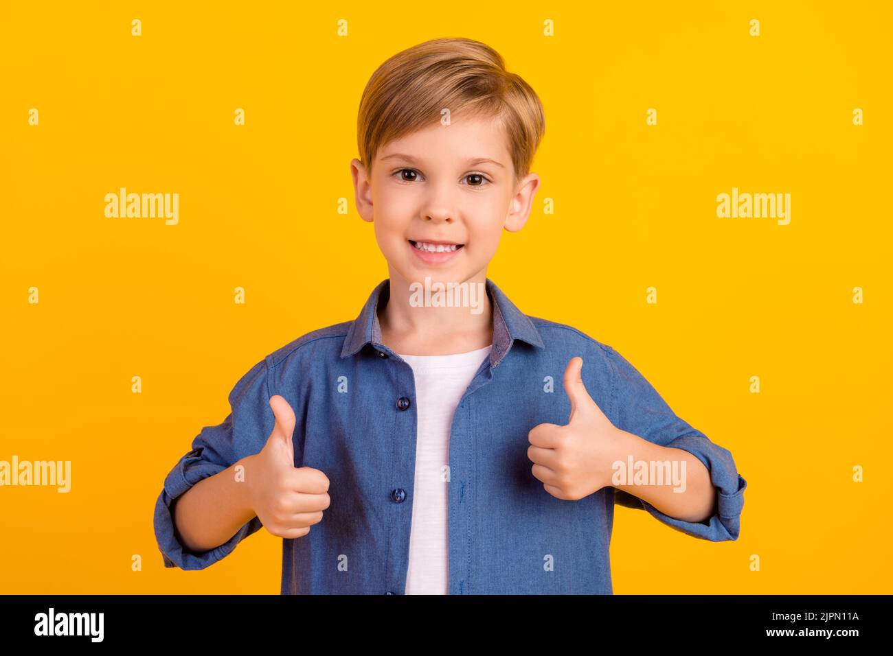 Portrait of positive friendly boy arms fingers demonstrate thumb up ...