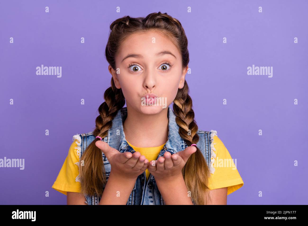 Photo of cute small blond girl blow kiss wear yellow t-shirt jeans vest ...