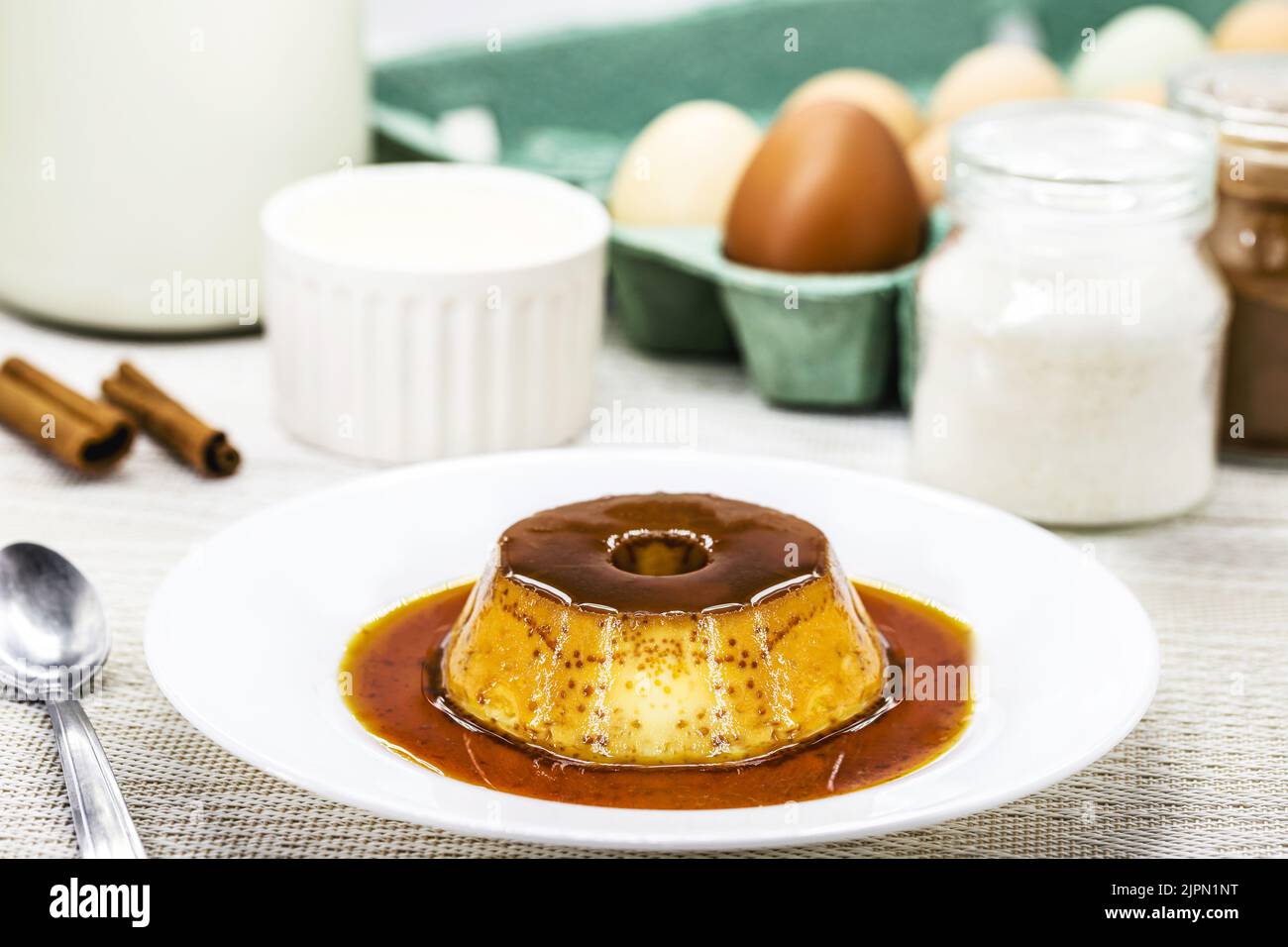 Small condensed milk pudding, with ingredients in the background, eggs ...
