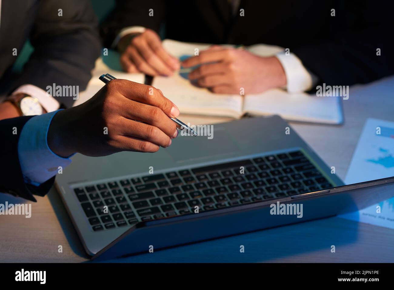 Coworkers discussing important information on screen of laptop Stock ...